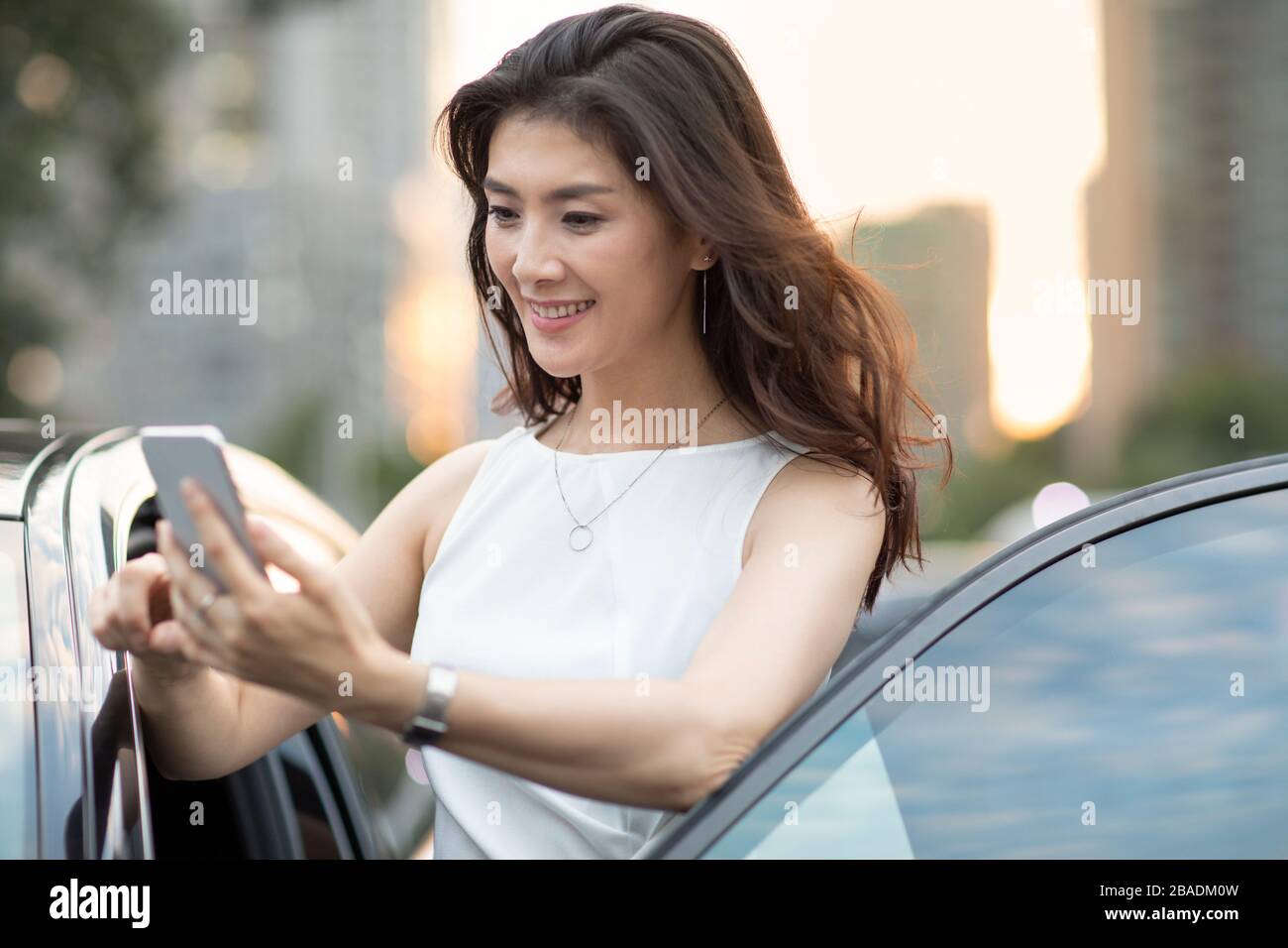 Confident Chinese businesswoman using smartphone Stock Photo - Alamy