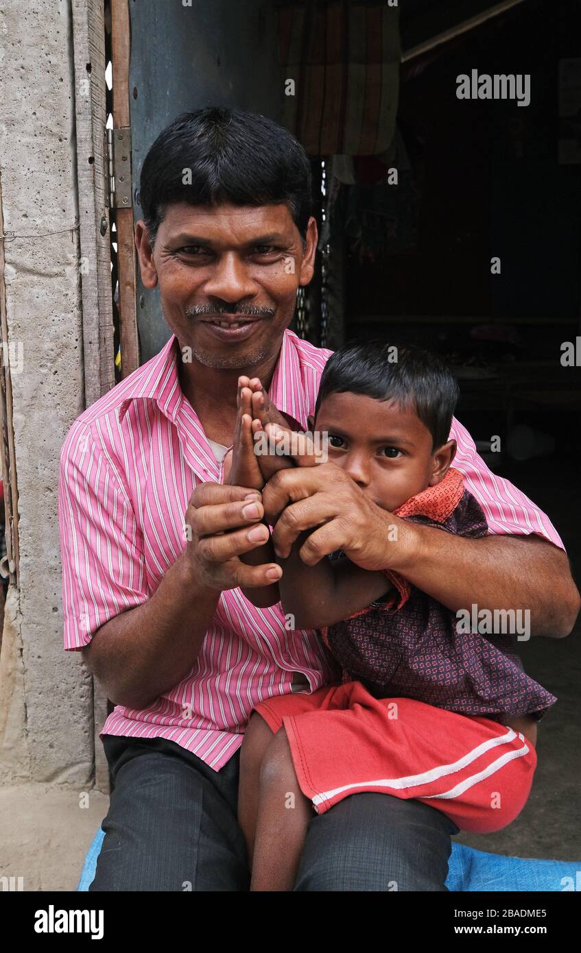 Father with his son during an outdoor Mass in Mitrapur village, West ...