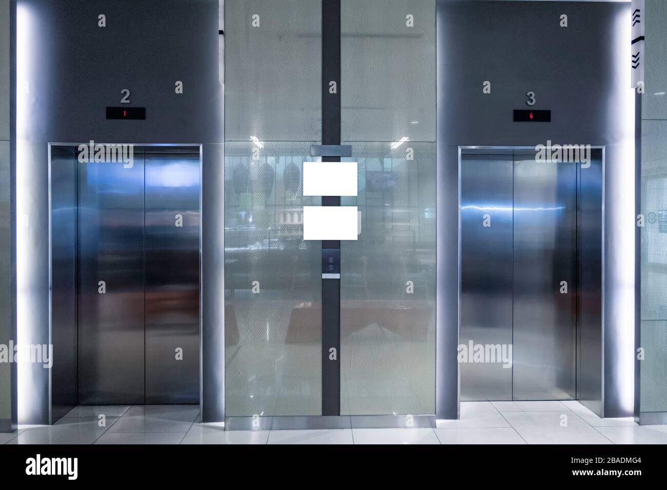 Closed two elevator doors glossy illuminated in lobby hotel Stock Photo ...