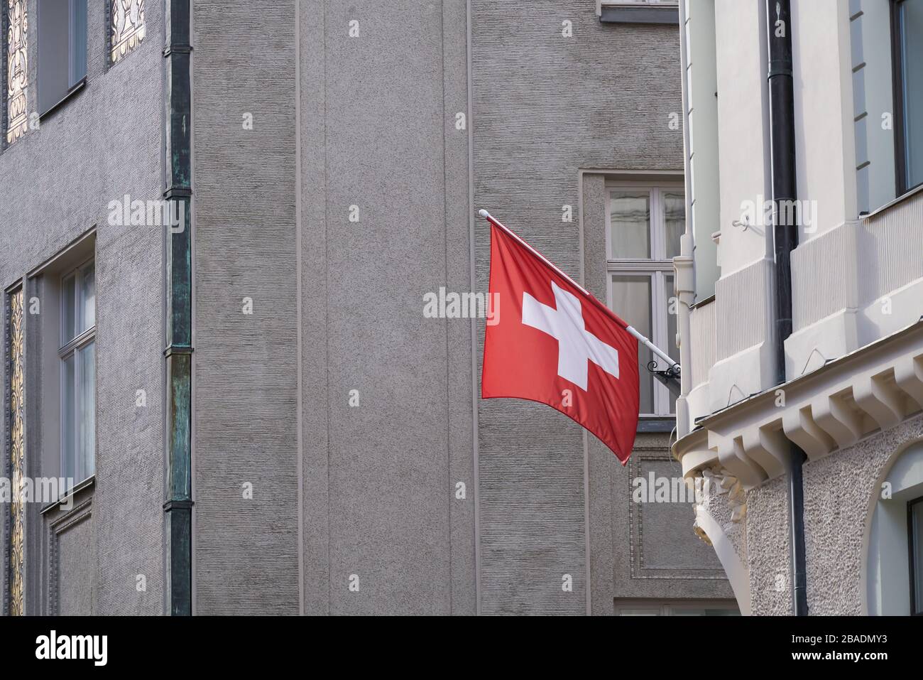 Swiss Flag hanging from Building Facade Stock Photo - Alamy