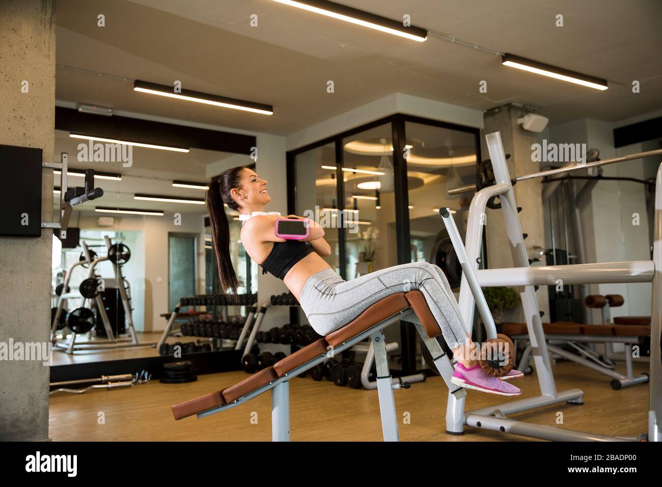 Pretty young woman have a training at sit up bench in the gym Stock ...