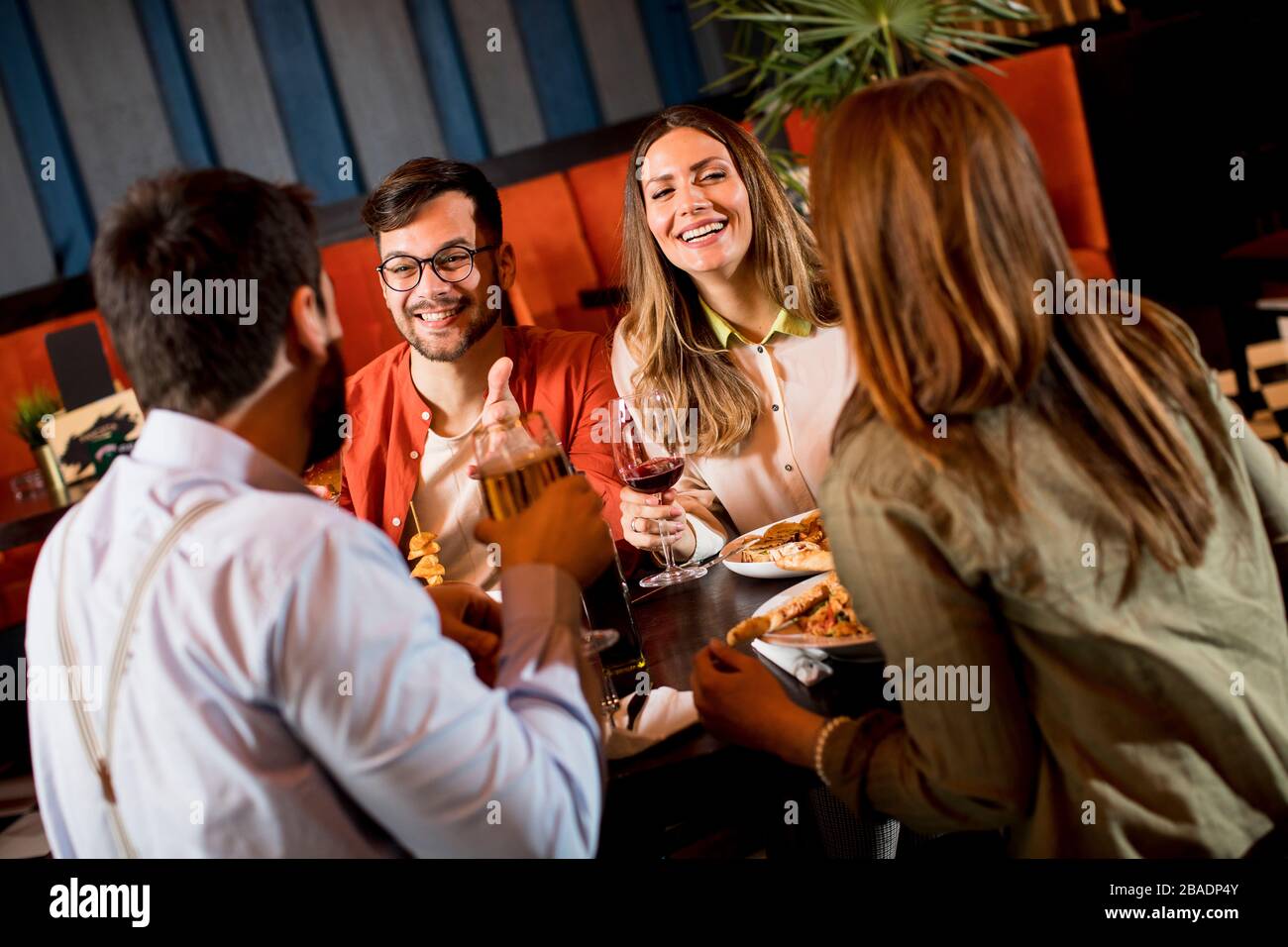 Group of young people having dinner in the restaurant Stock Photo - Alamy