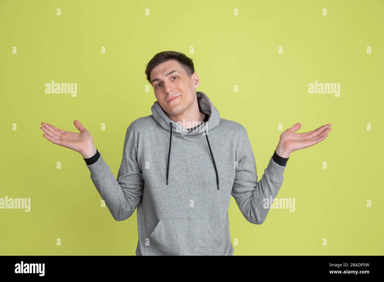 Doesn't know, uncertain. Caucasian man's portrait isolated on yellow ...