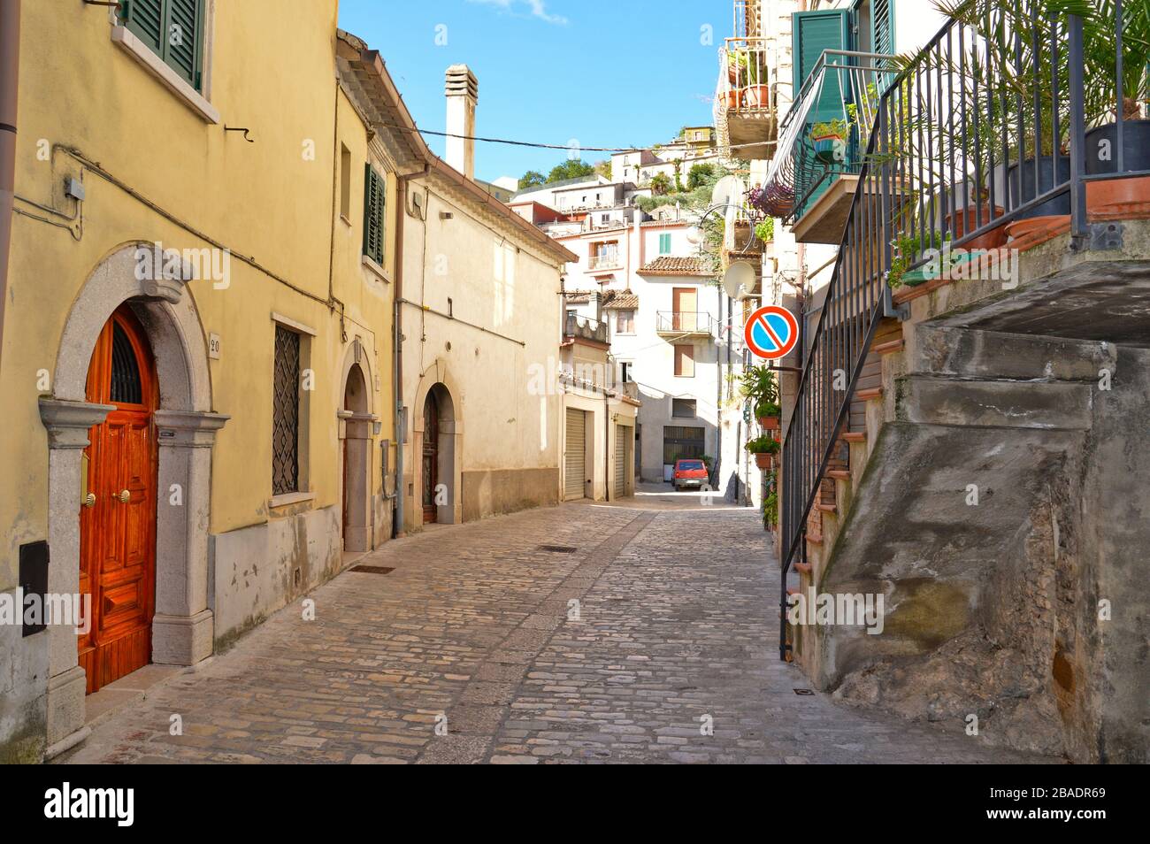 A narrow street between the houses of Morcone, a medieval village in ...
