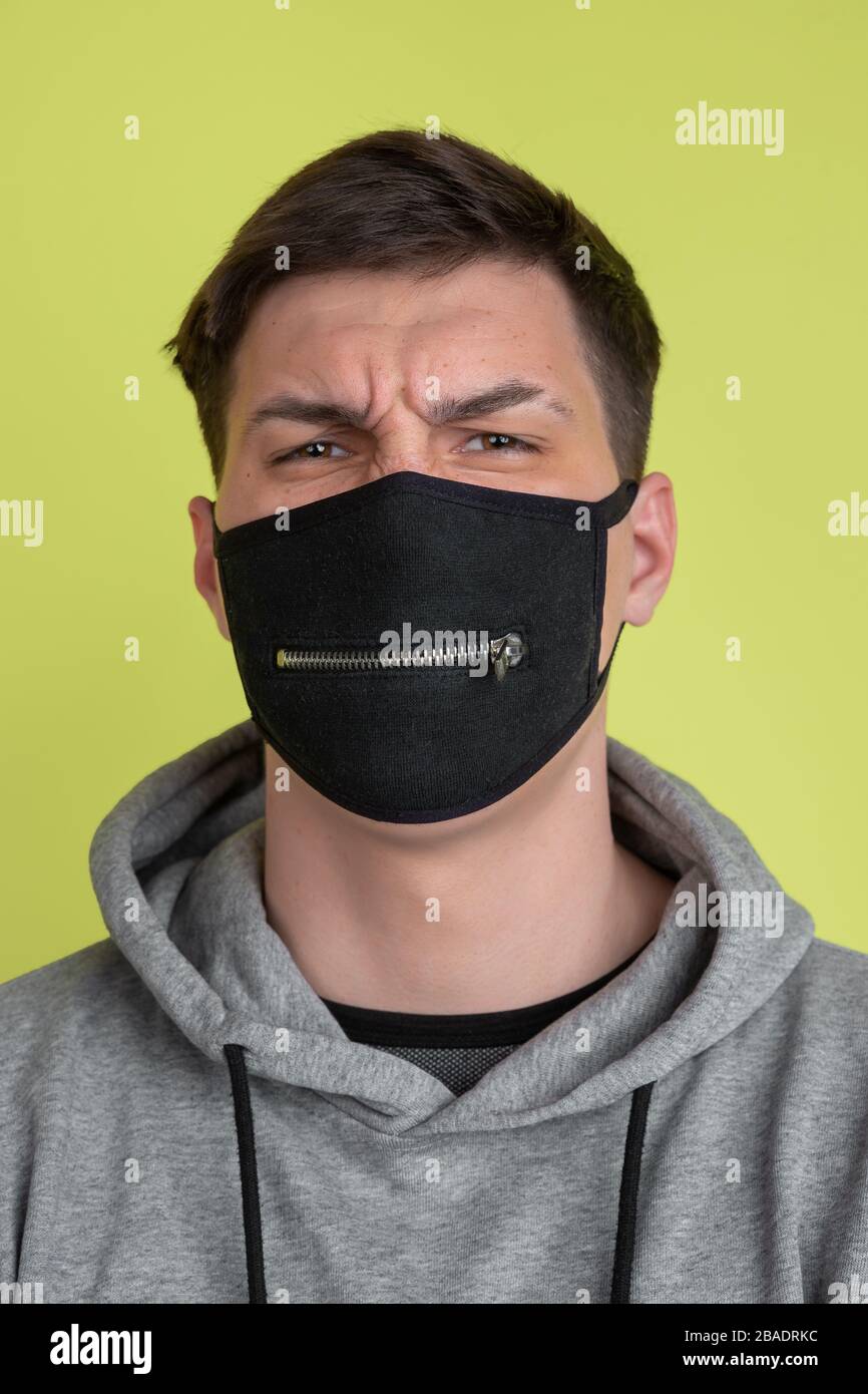 Hard thinking. Caucasian man's portrait isolated on yellow studio ...