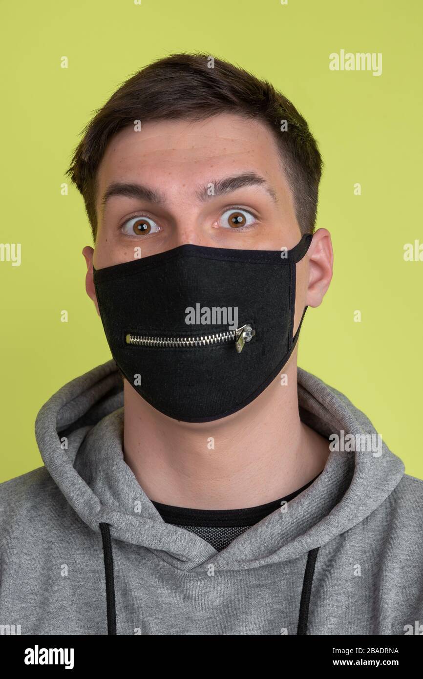 Astonished eyes. Caucasian man's portrait isolated on yellow studio ...
