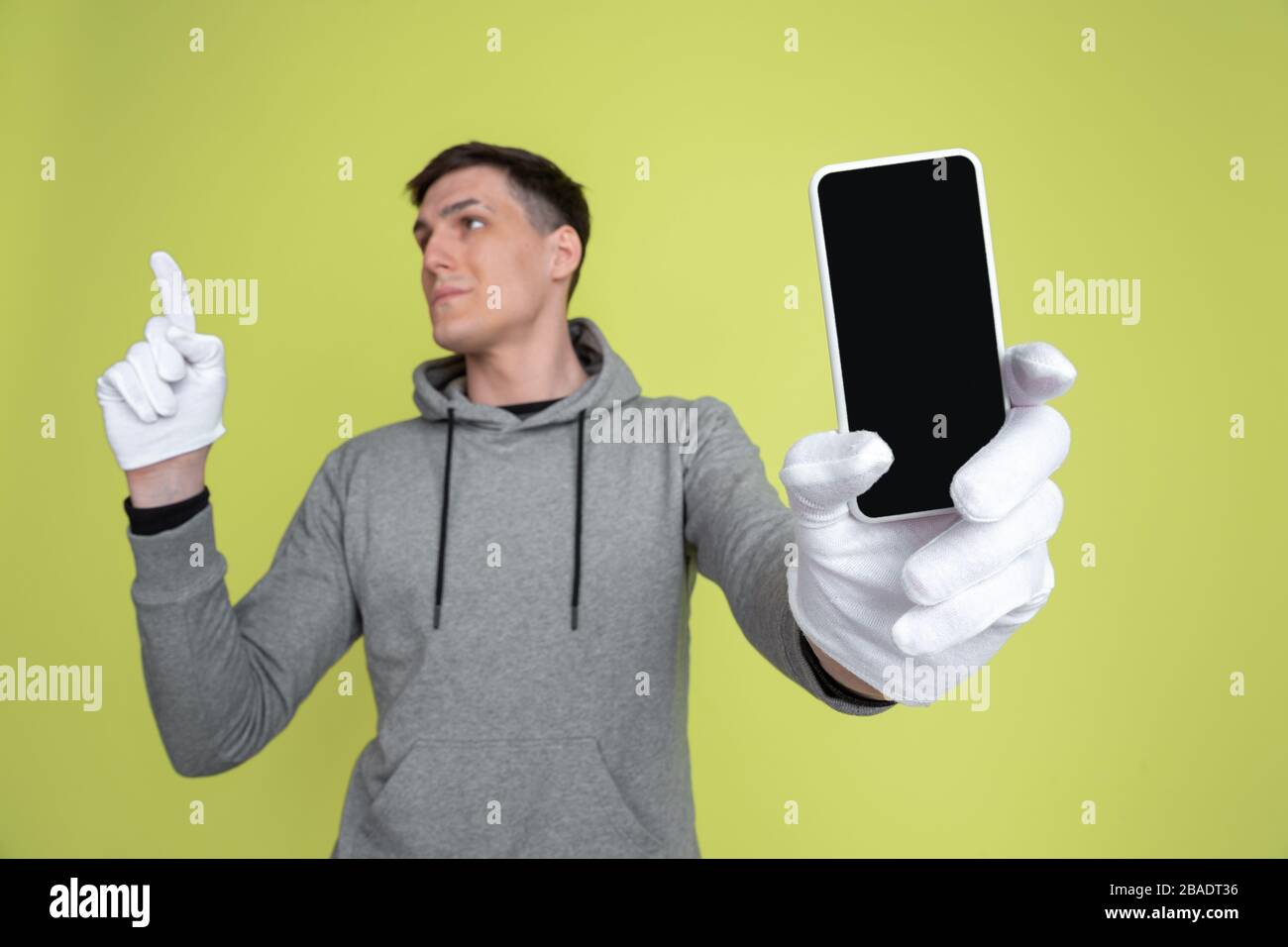 Showing phone's blank screen. Caucasian man's portrait isolated on ...