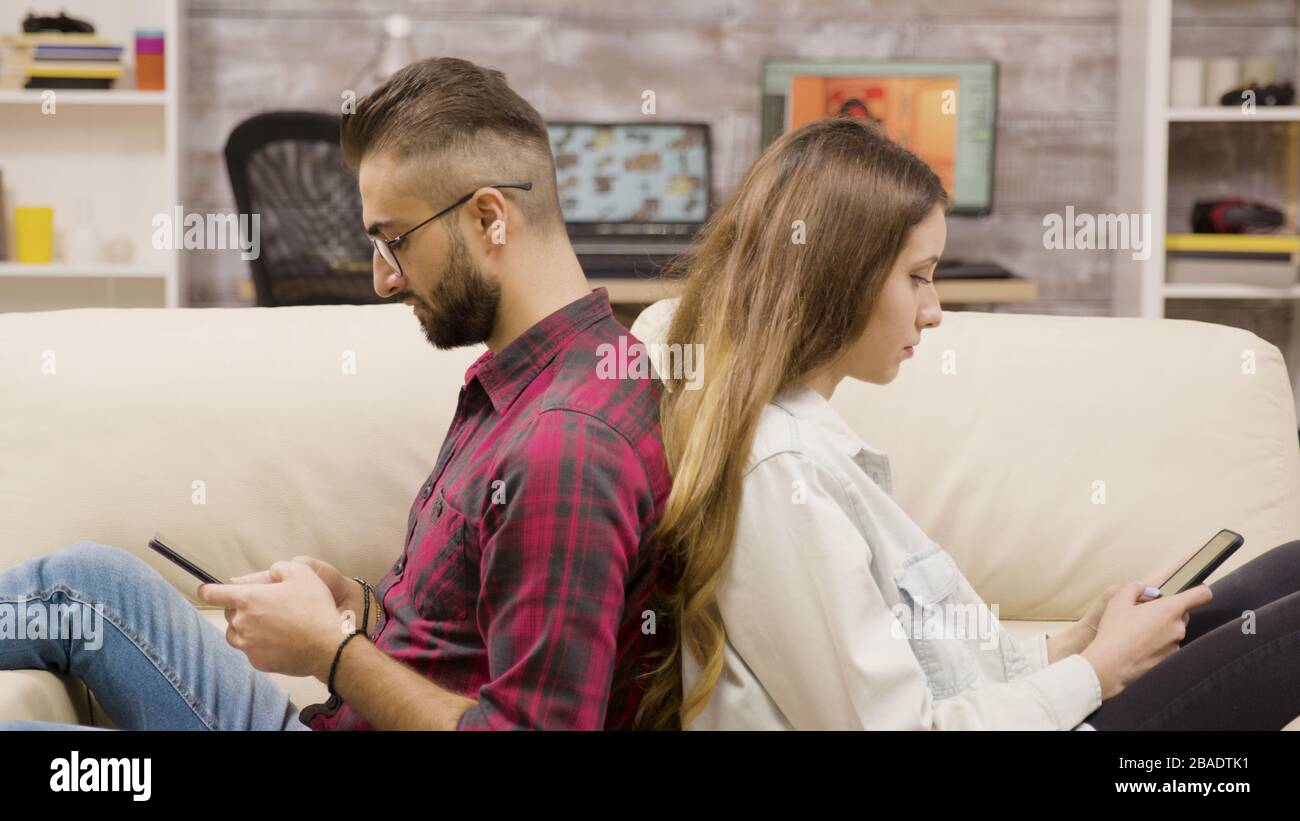 Upset Couple Sitting Back To Back And Ignoring Each Other Couple