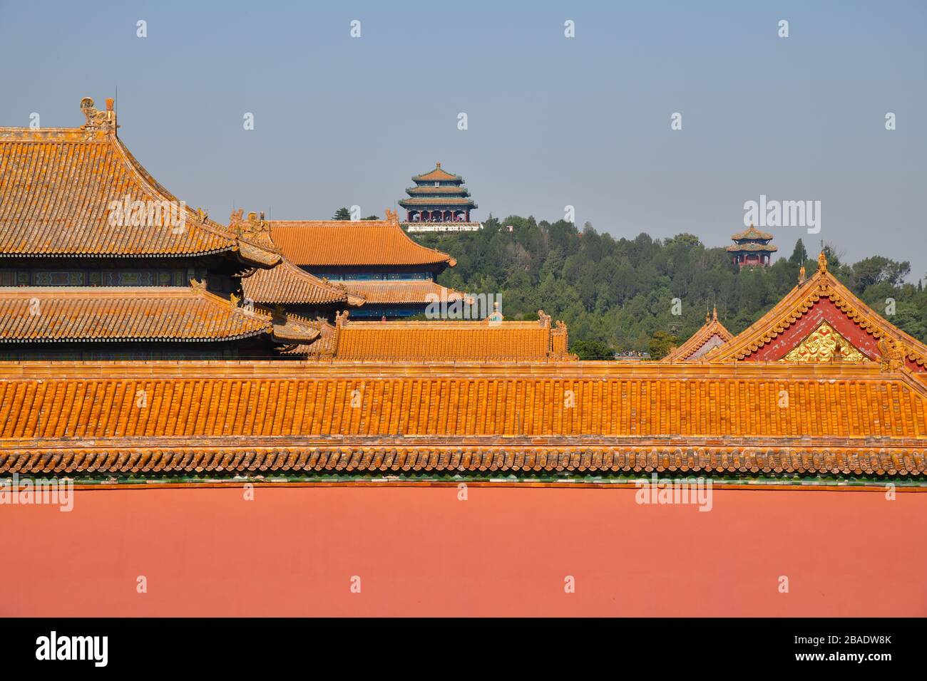 Compressed view at roof level of colorful red wall and red roofs of ...
