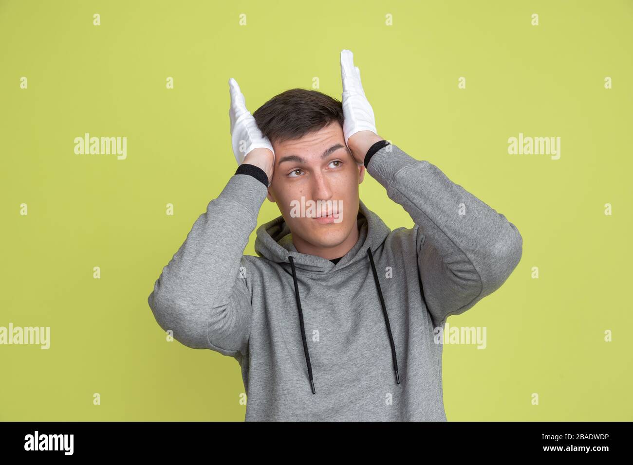 Astonished, shocked. Caucasian man's portrait isolated on yellow studio ...