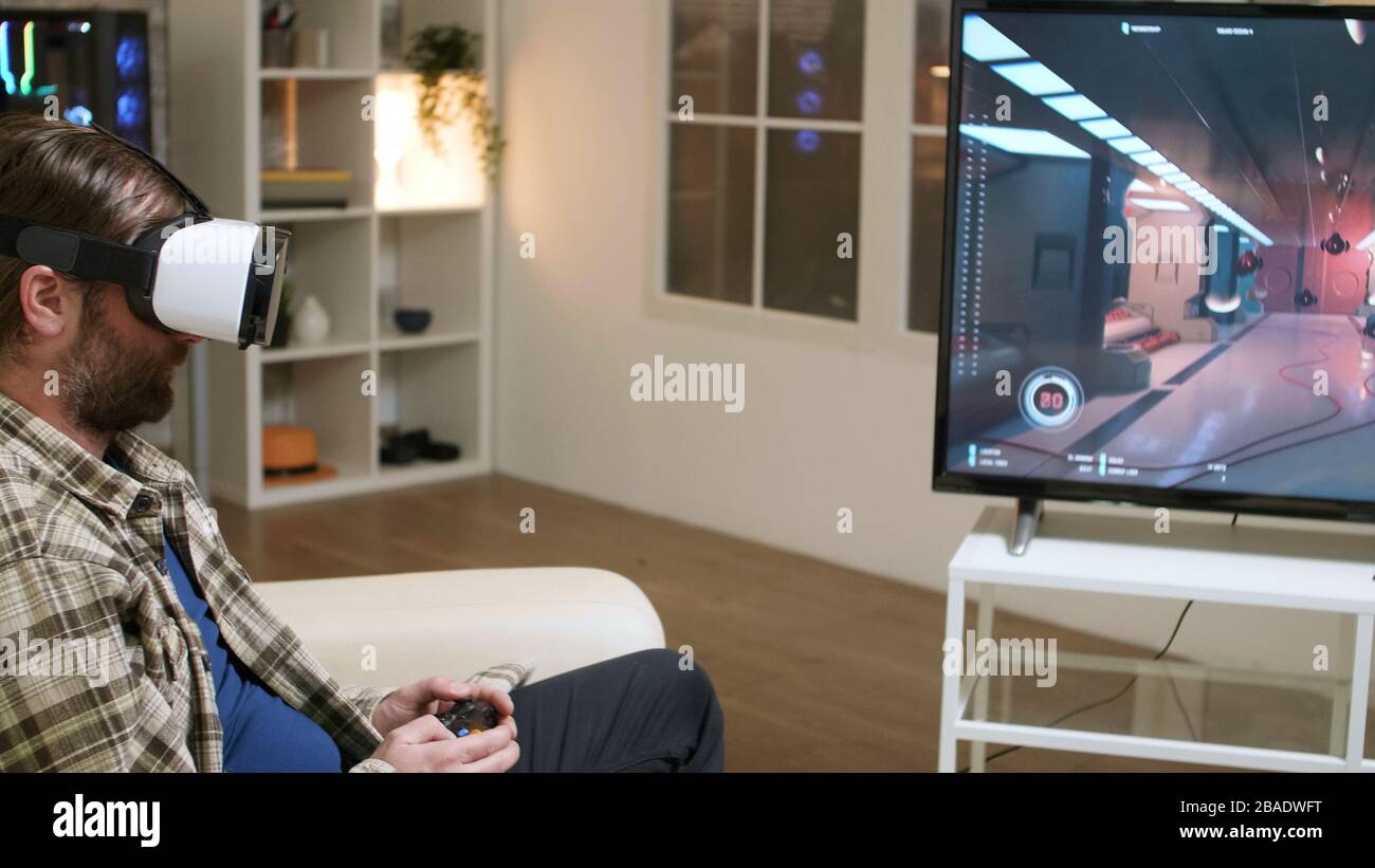 Bearded man with long hair taking off vr headset after losing while ...