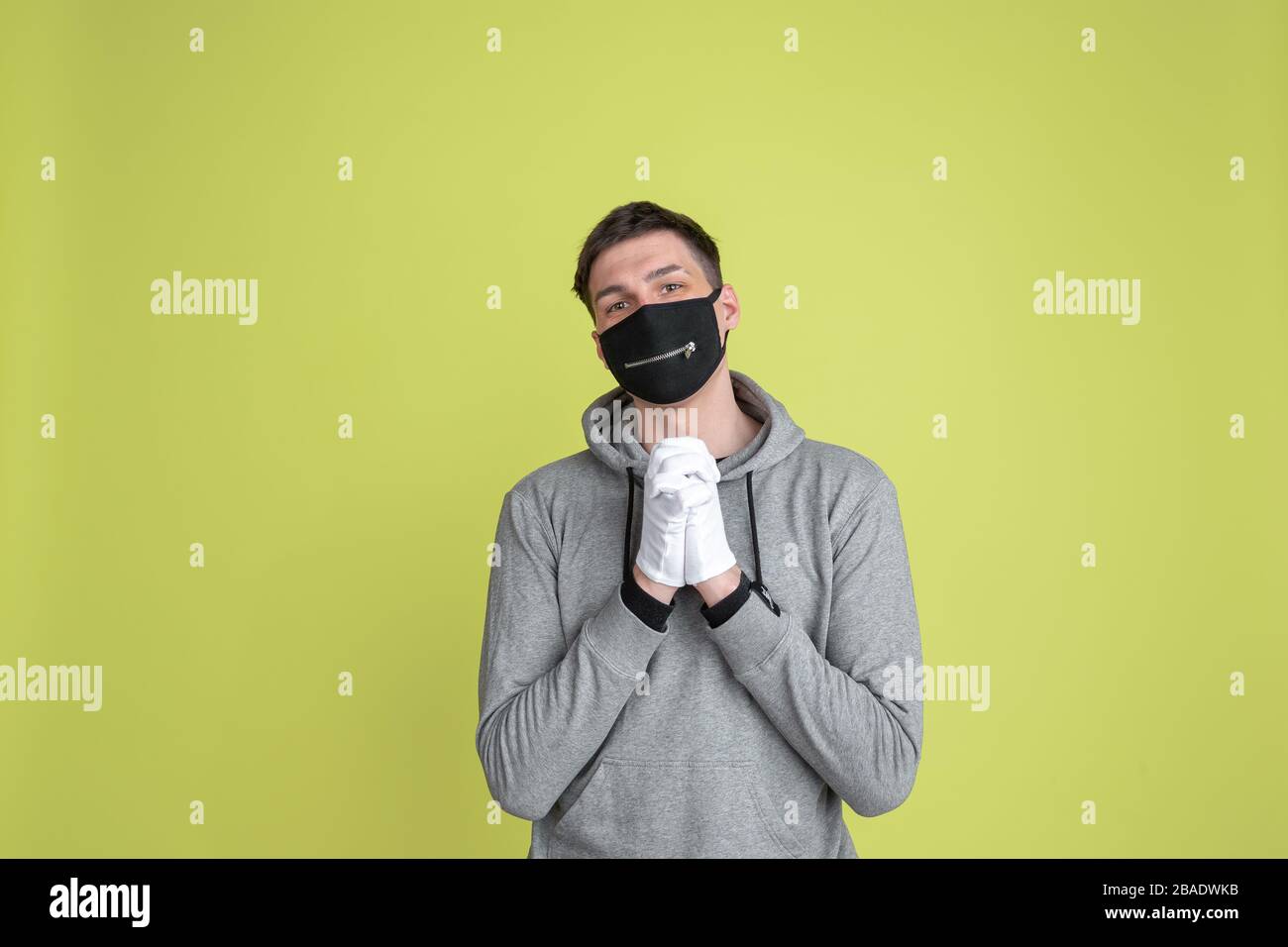 Cute posing. Caucasian man's portrait isolated on yellow studio ...