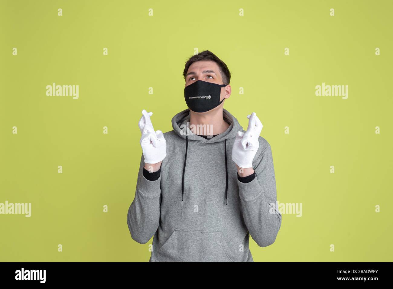 Good luck gesture. Caucasian man's portrait isolated on yellow studio ...
