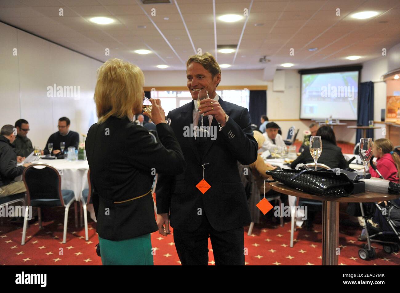 VIP guests enjoy a glass of Champagne at Lingfield Races Stock Photo ...