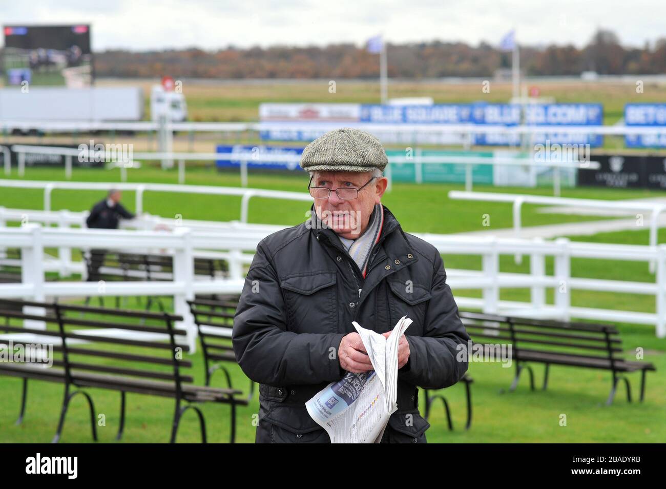 A racegoer reads the Racing Post as he studies the form at Lingfield ...