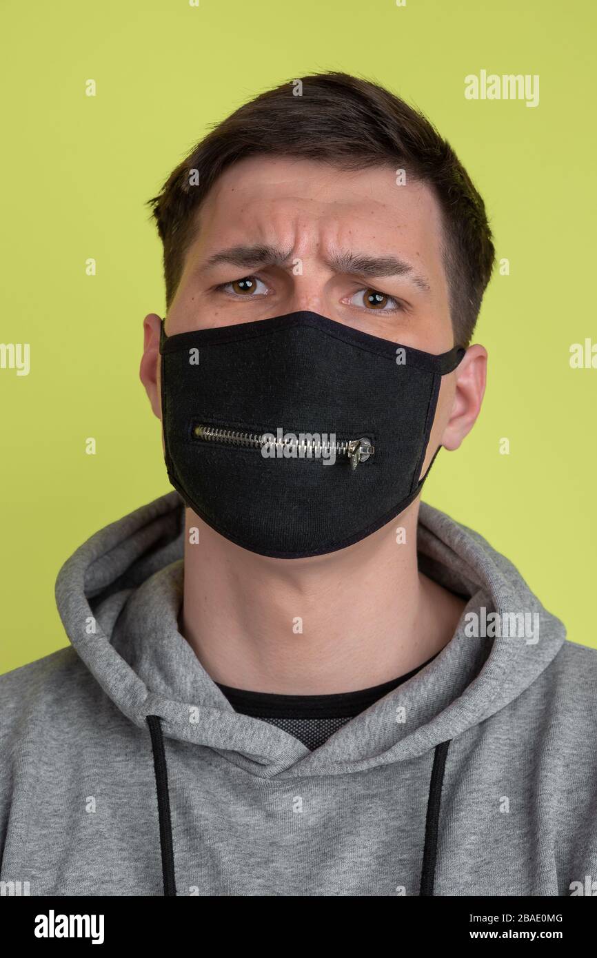 Asking. Close up caucasian man's portrait isolated on yellow studio ...