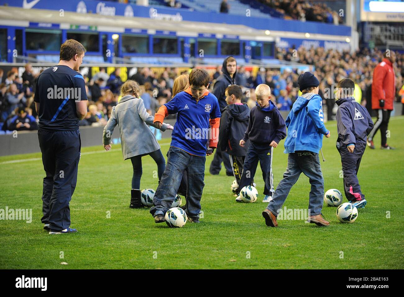 Kids coaching on the pitch at half-time Stock Photo - Alamy