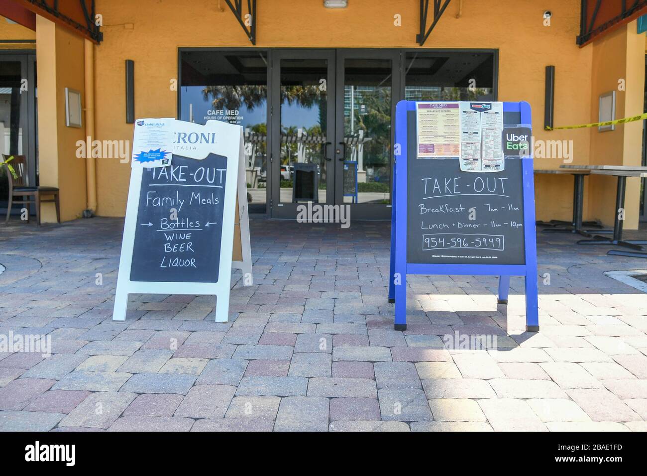 Take-out food signs line the sidewalk at Burger Craze Restaurant amid ...