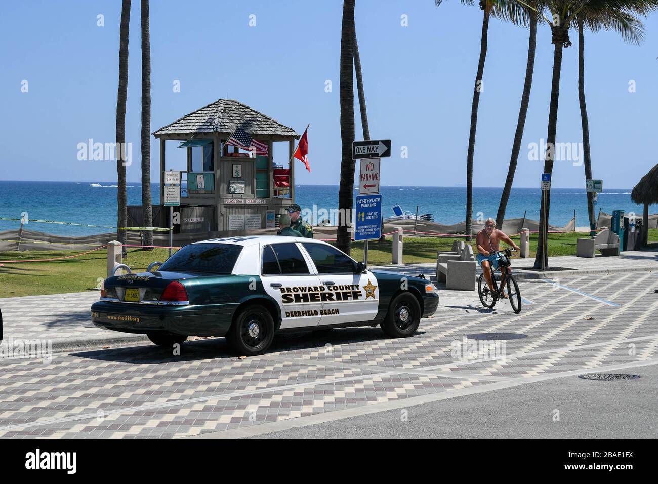 Broward County Sheriff deputies monitor the closed beach amid the ...
