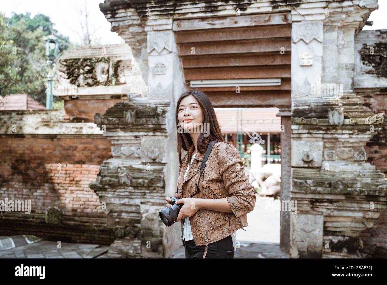 woman having fun in the city in indonesia with camera travel photo of ...
