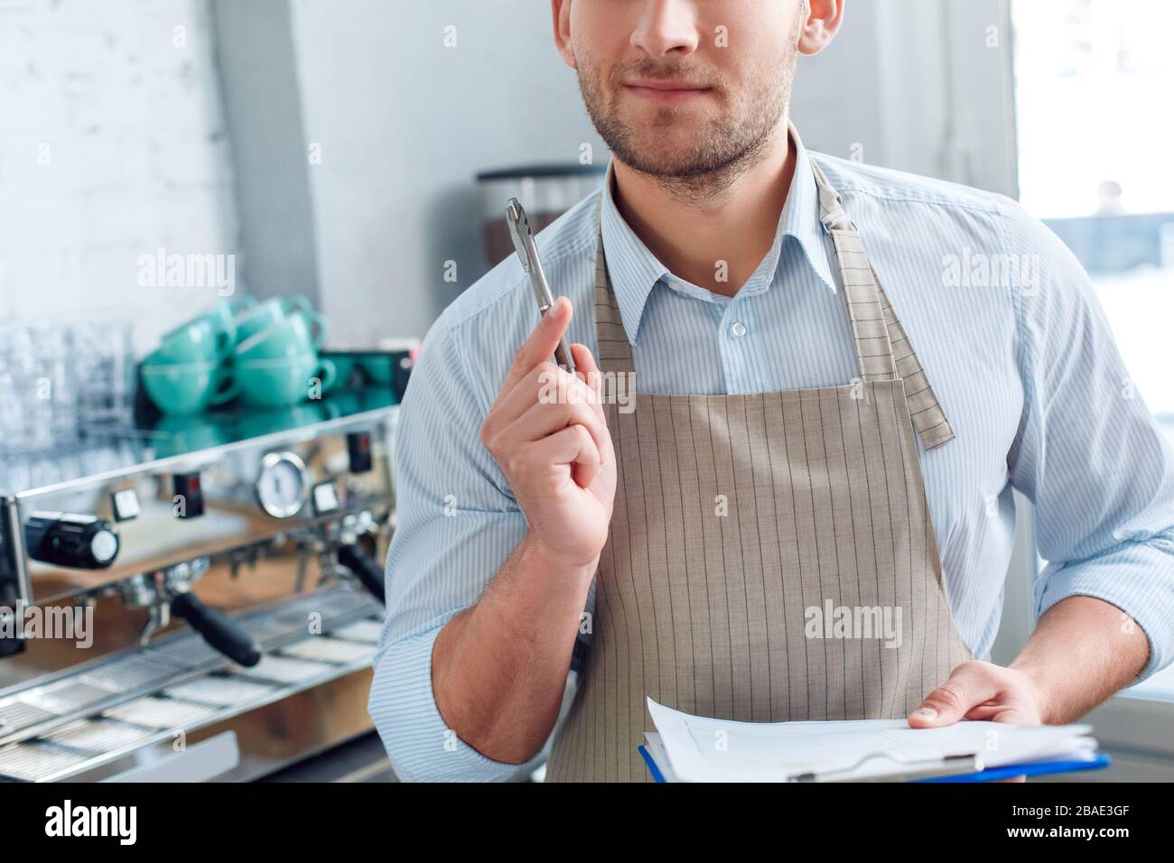 Young pensive male barista hi-res stock photography and images - Alamy