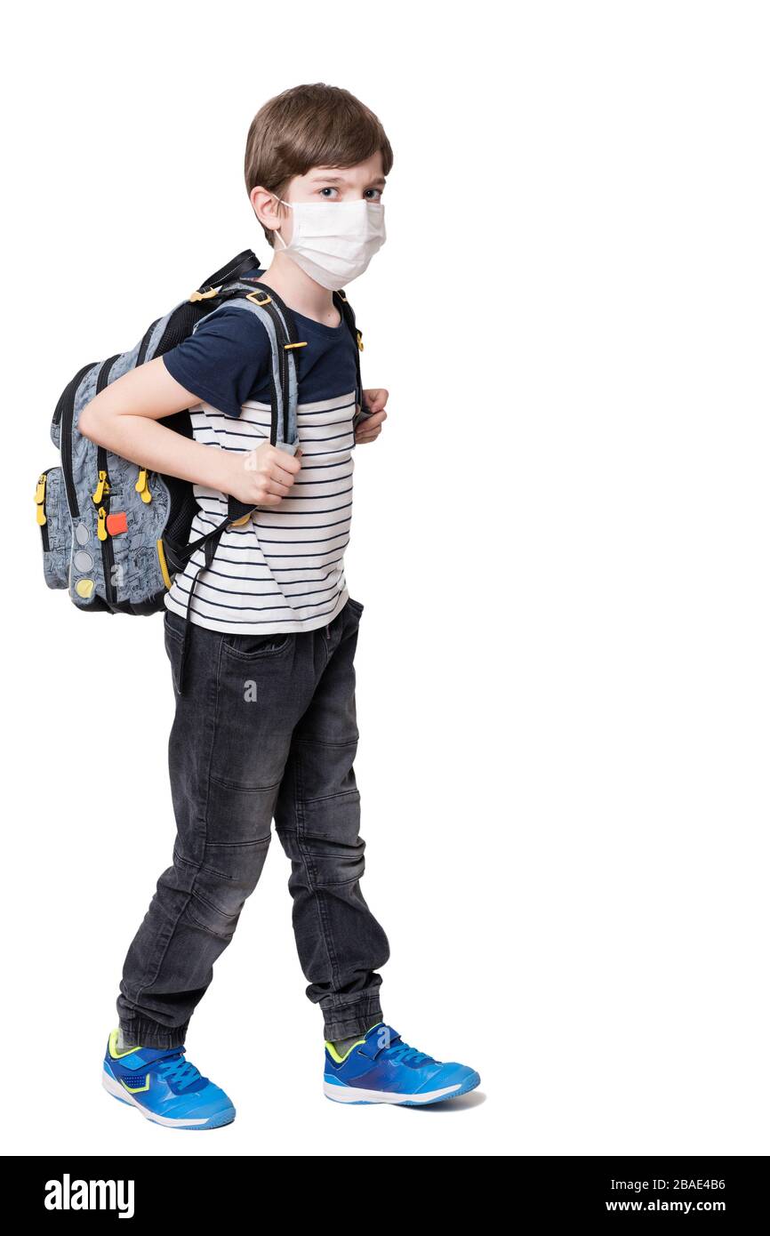 Portrait of kid with face mask holding school bag, isolated on white ...