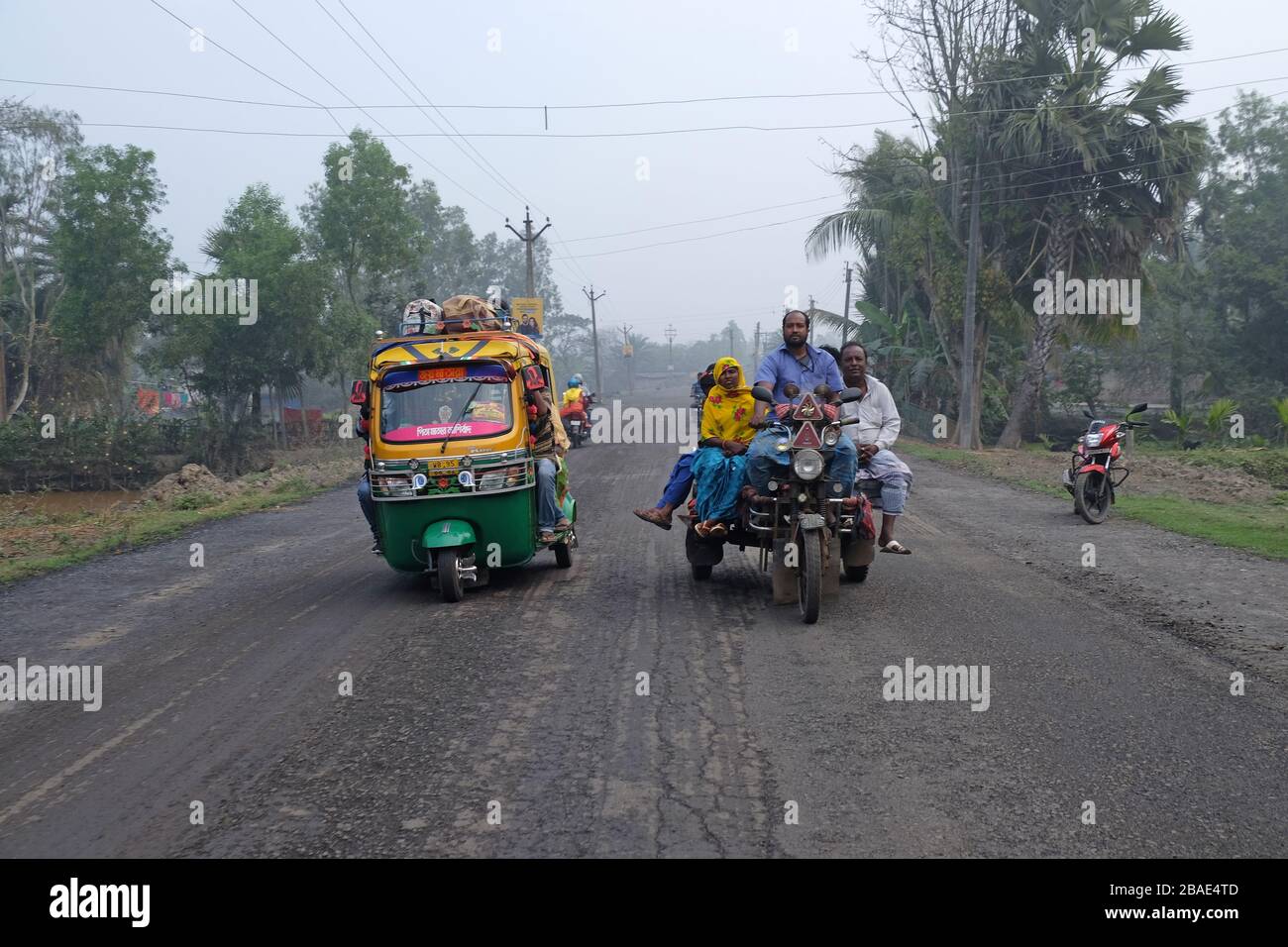Indian tricycle motor rickshaw carrying passenger, Kumrokhali, West ...