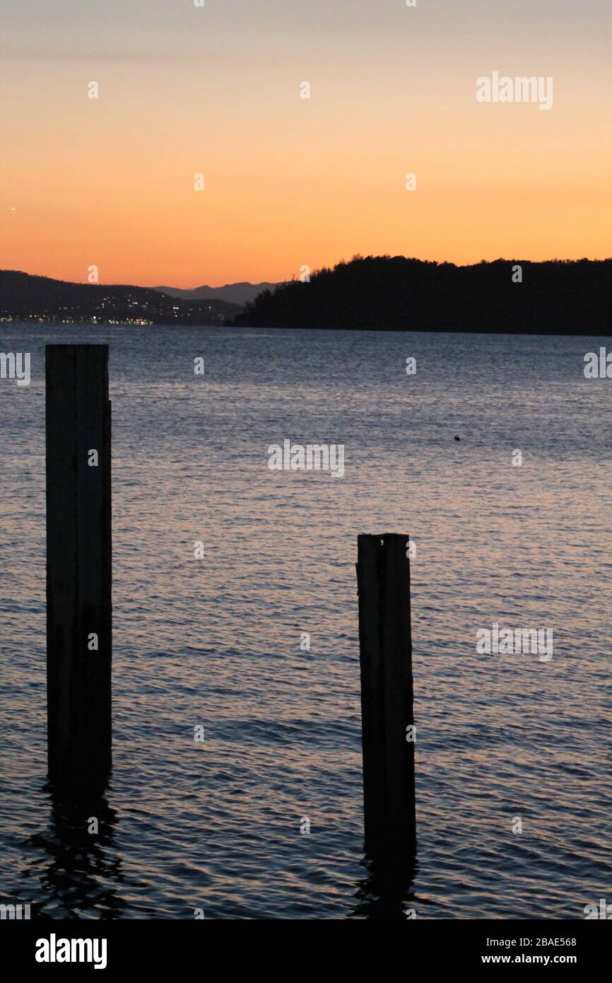 A sunset over a body of water Stock Photo - Alamy