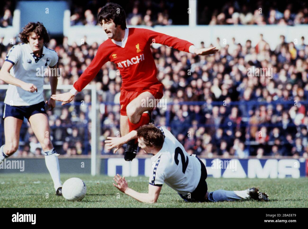 Liverpool's David Johnson (c) hurdles a challenge from Tottenham ...