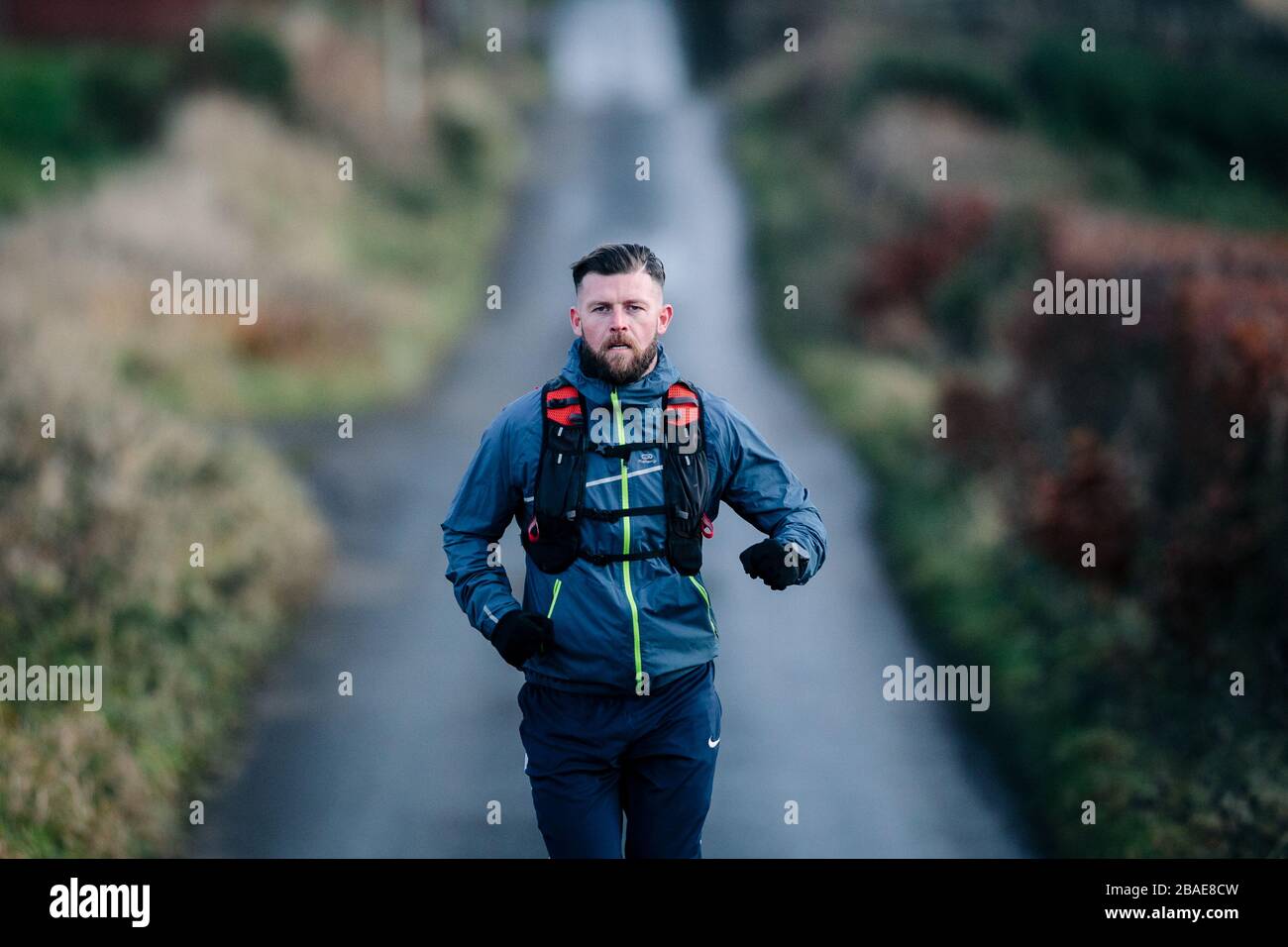 Man running on road, Glasgow, Scotland Stock Photo - Alamy