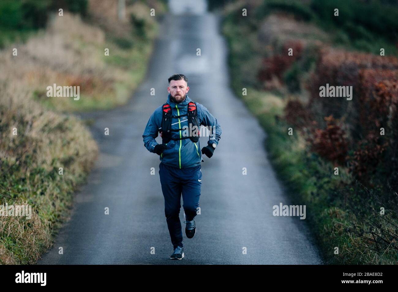Man running on road, Glasgow, Scotland Stock Photo - Alamy