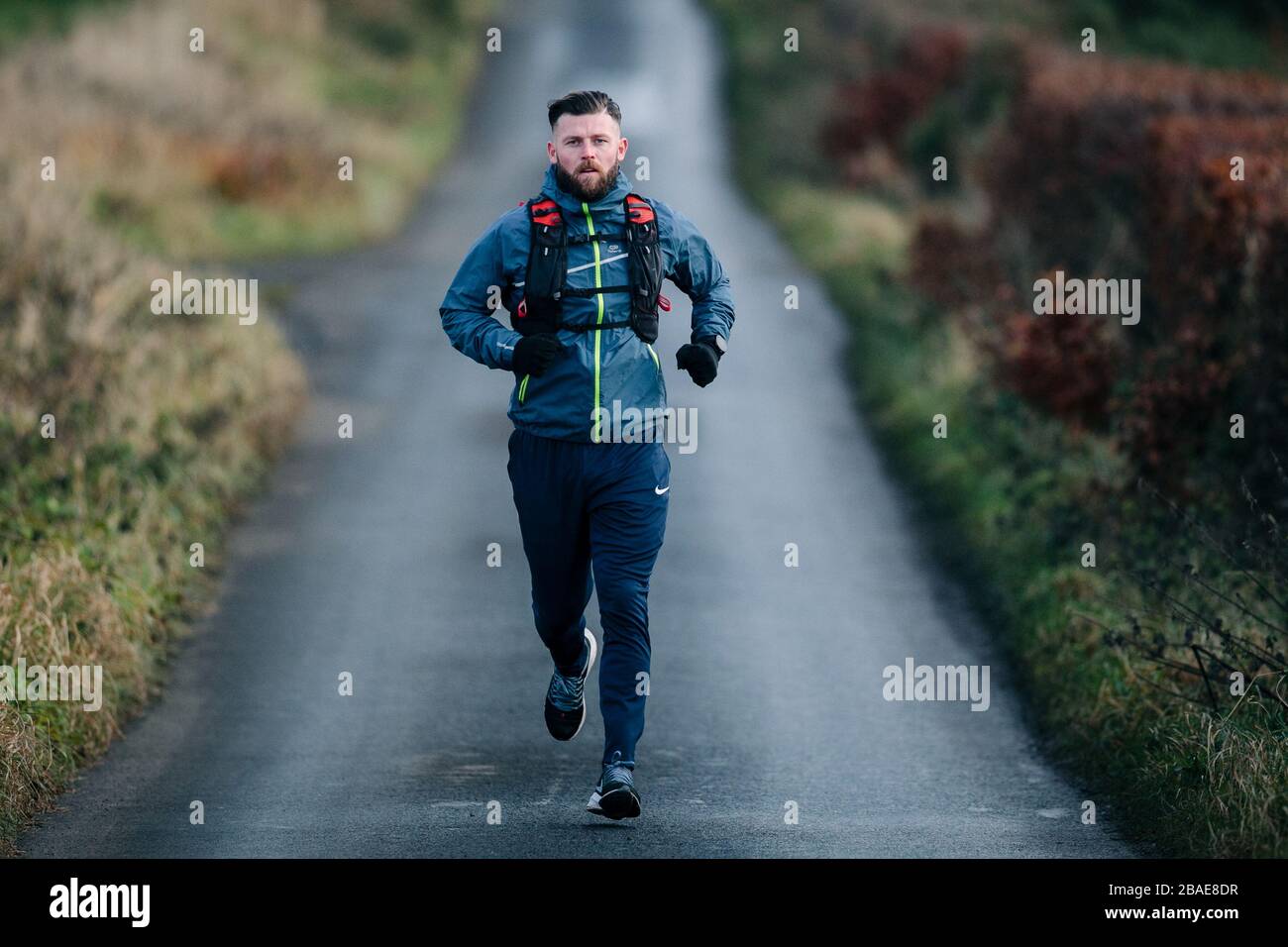 Man running on road, Glasgow, Scotland Stock Photo - Alamy