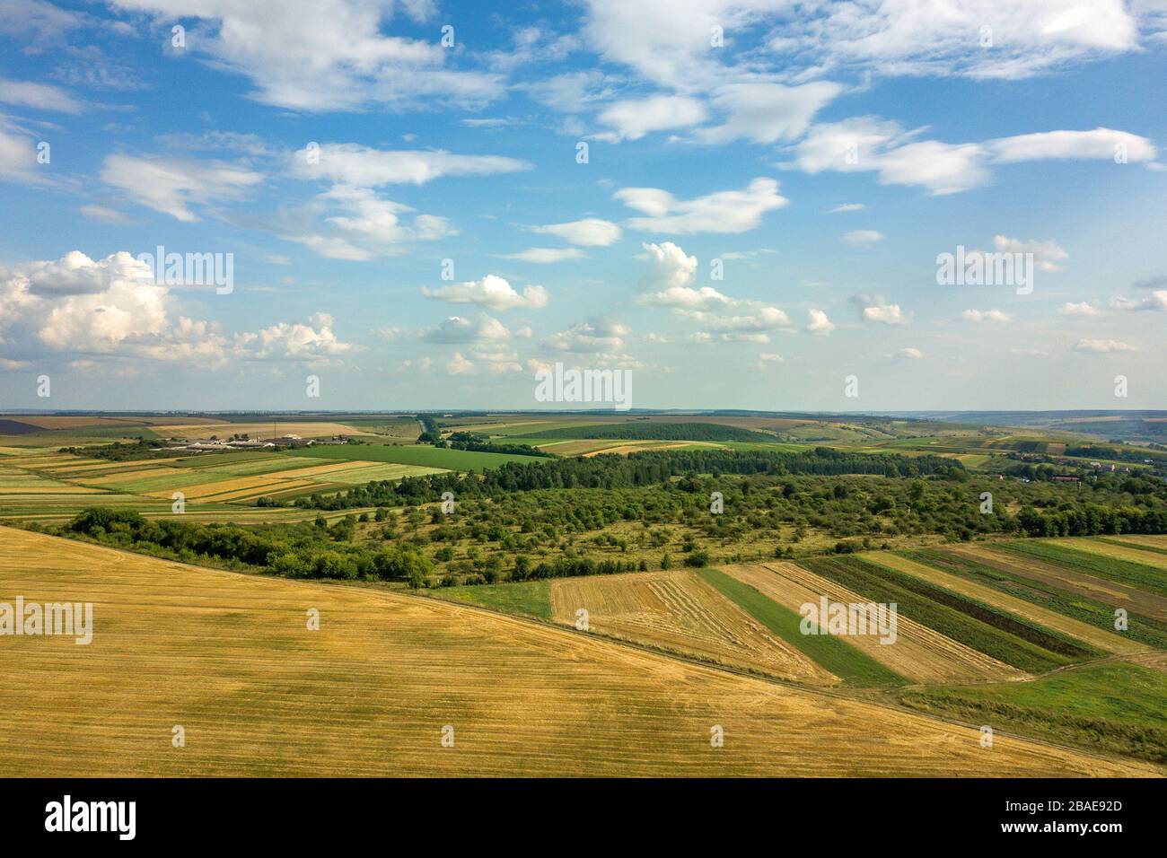 Aerial rural landscape with yellow patched agriculture fields and blue ...