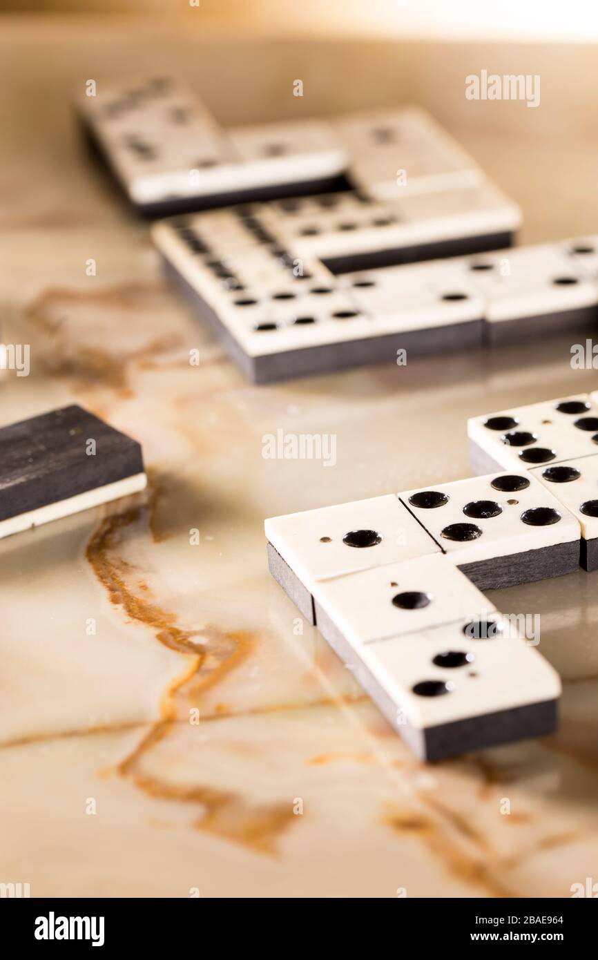 Domino as an abstract concept. Beautiful antique domino set on marble ...