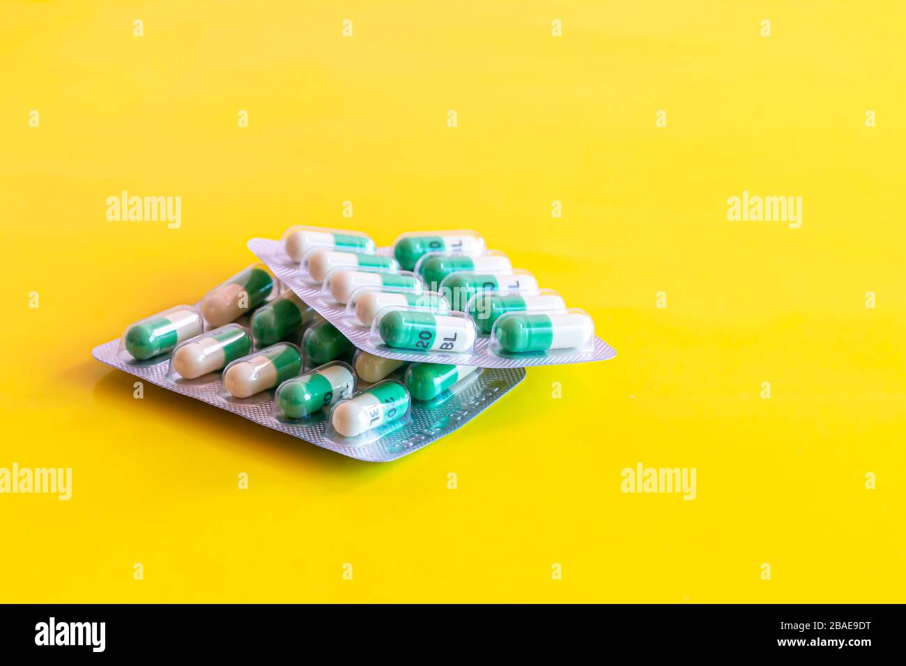 Two blisters of antidepressant tablets on spring yellow background with ...