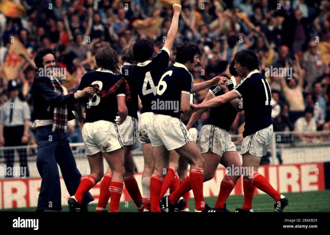 l-r; A fan races on to congratulate Scotland on scoring their opening ...