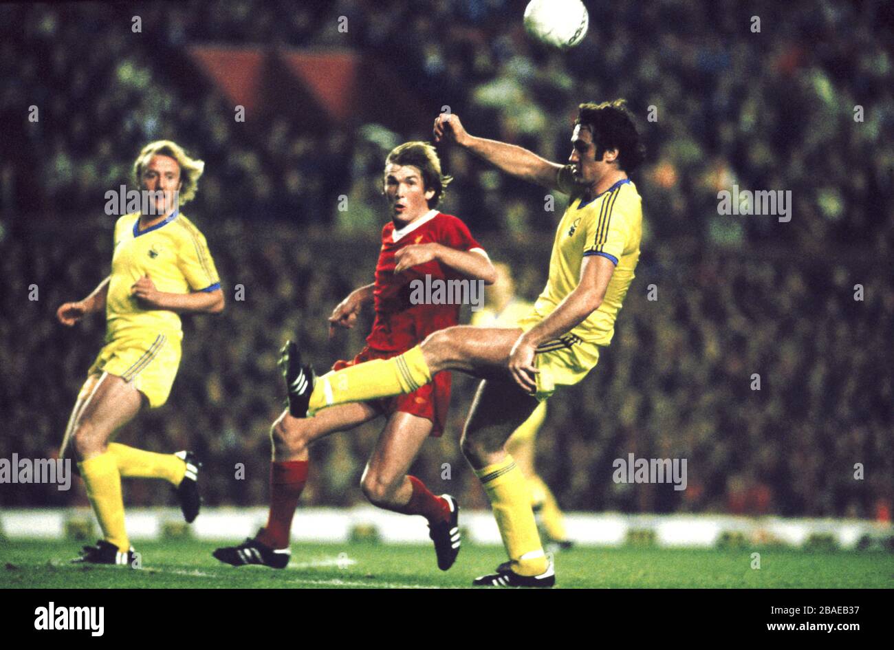 Nottingham Forest's Larry Lloyd (right) clears from Liverpool's Kenny ...