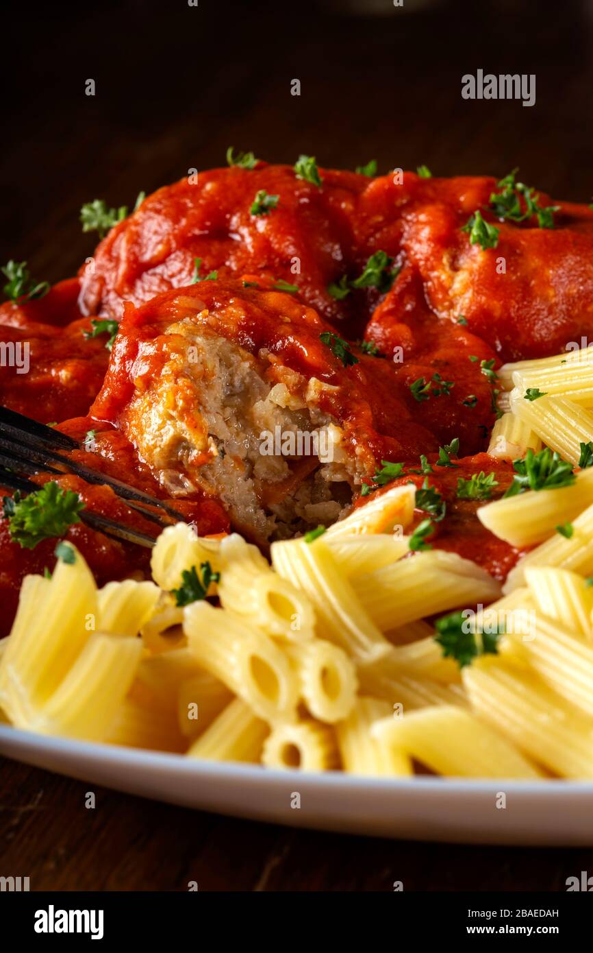 Eating meatballs in tomato sauce with pasta - close up view Stock Photo ...