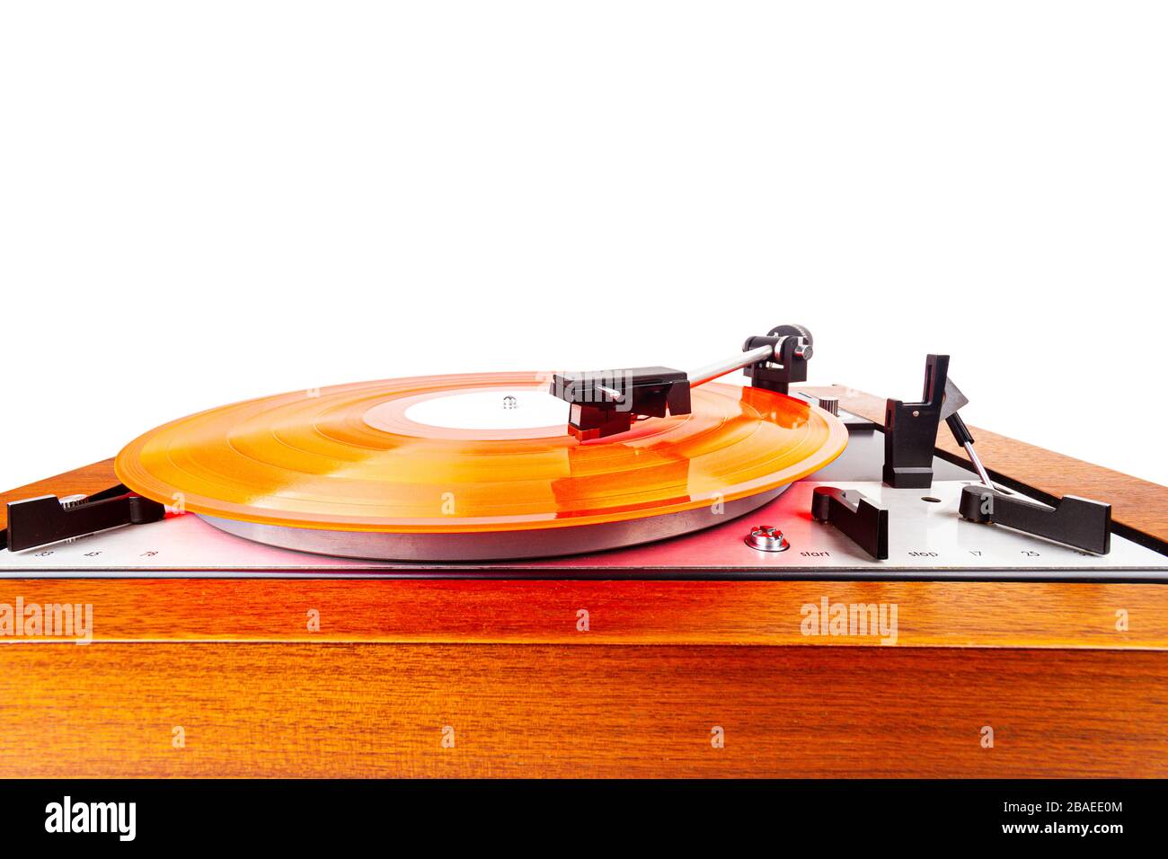 Vintage turntable with a red vinyl isolated on white. Wooden plinth ...