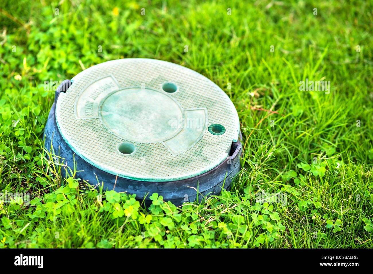 Closeup of green plastic pipe with cover on green grass lawn Stock ...