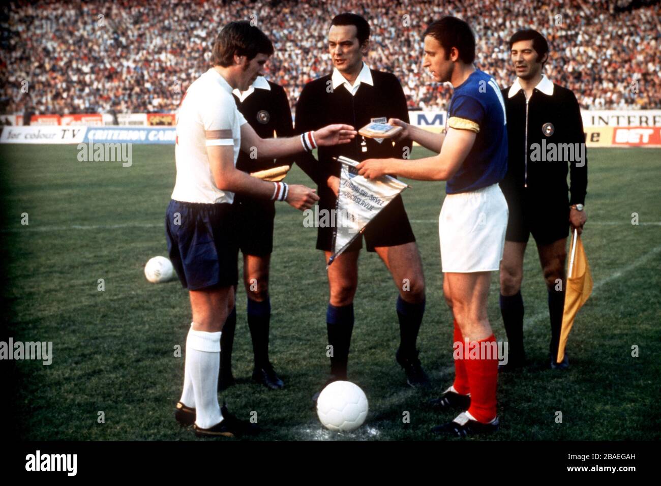England captain Emlyn Hughes (l) exchanges pennants with Yugoslavia ...