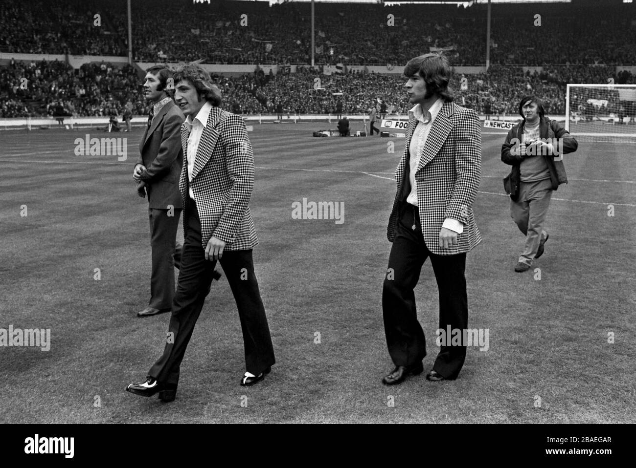 Newcastle United's Alan Kennedy (c) and Malcolm MacDonald (r) take a ...