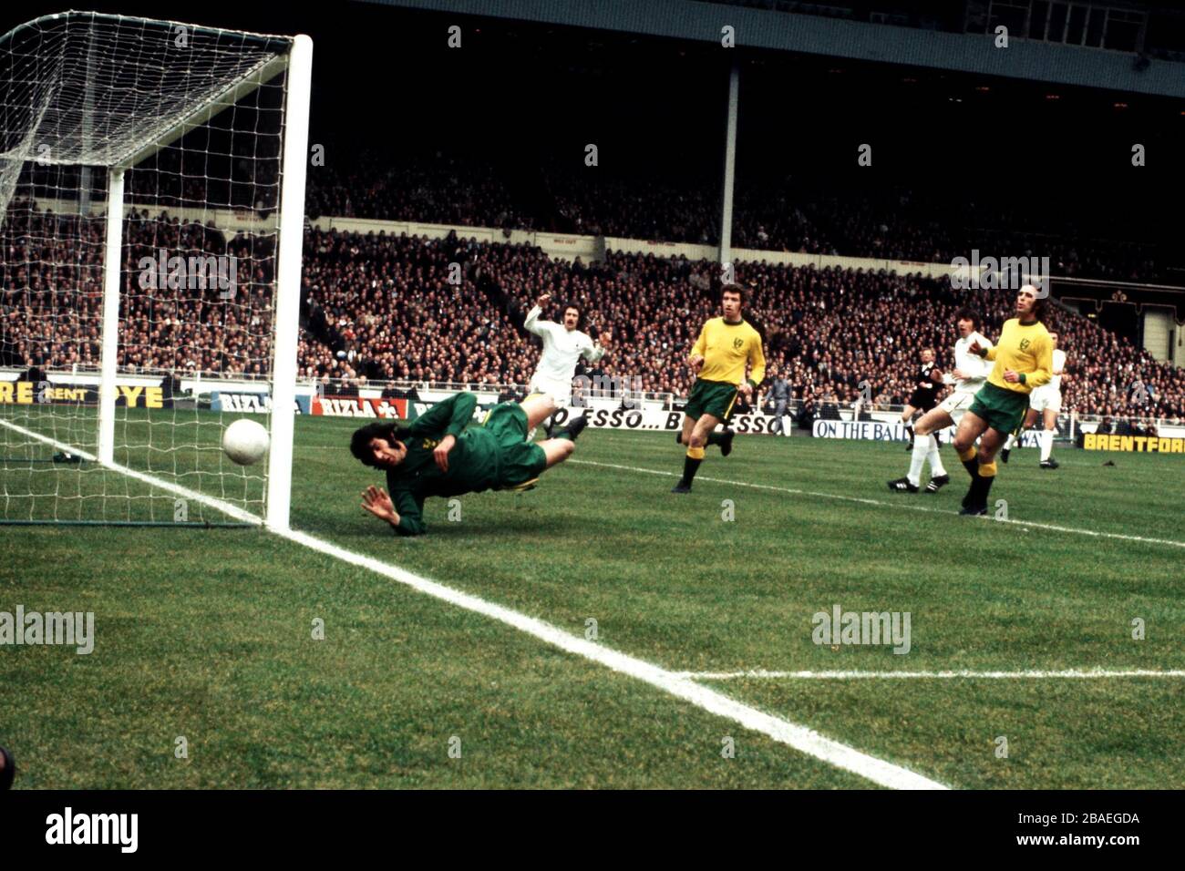Norwich City goalkeeper Kevin Keelan (l) pushes a shot around the post ...