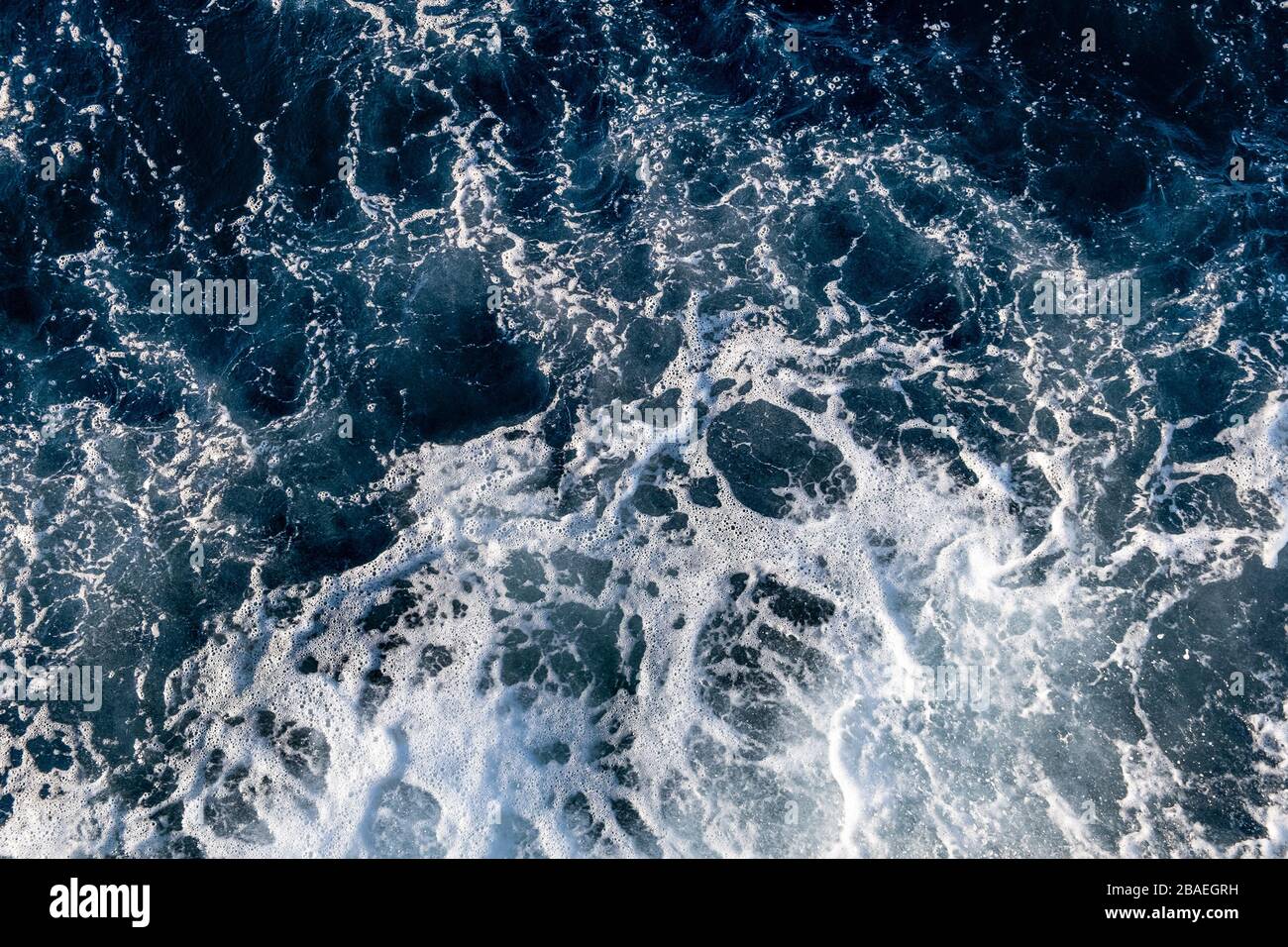 Top down aerial view of sea water surface. White foam waves texture as ... Top down aerial view of sea water surface. White foam waves texture as ...