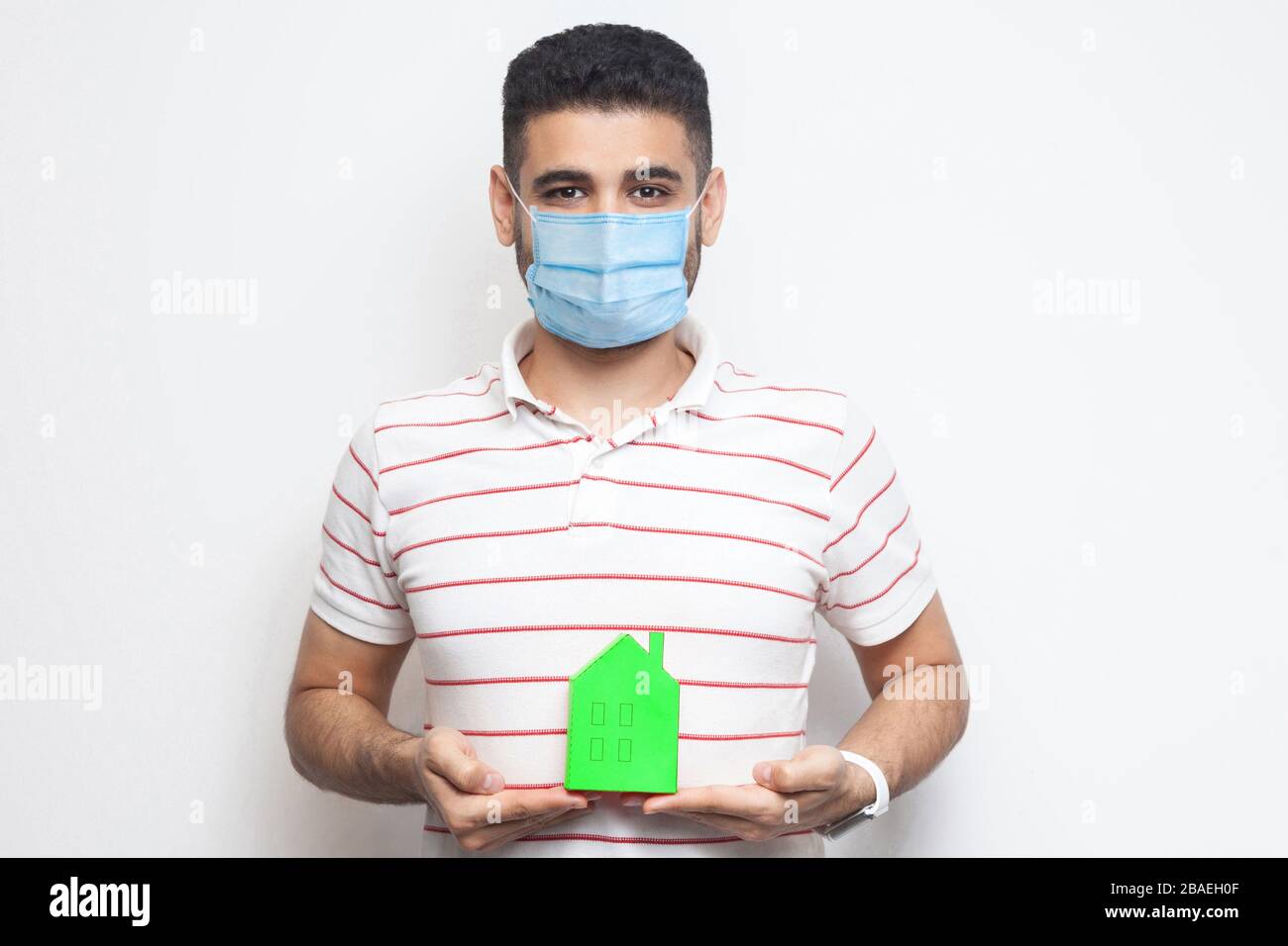 Stay at home, stay safe. Positive man with surgical medical mask ...