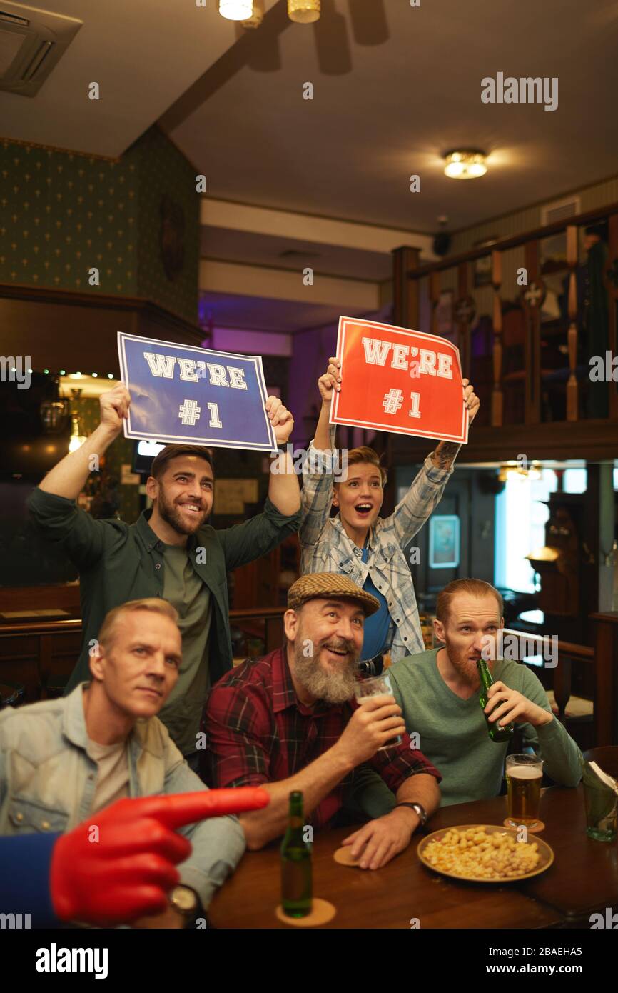 Group of people raising placards in their hands and watching football ...
