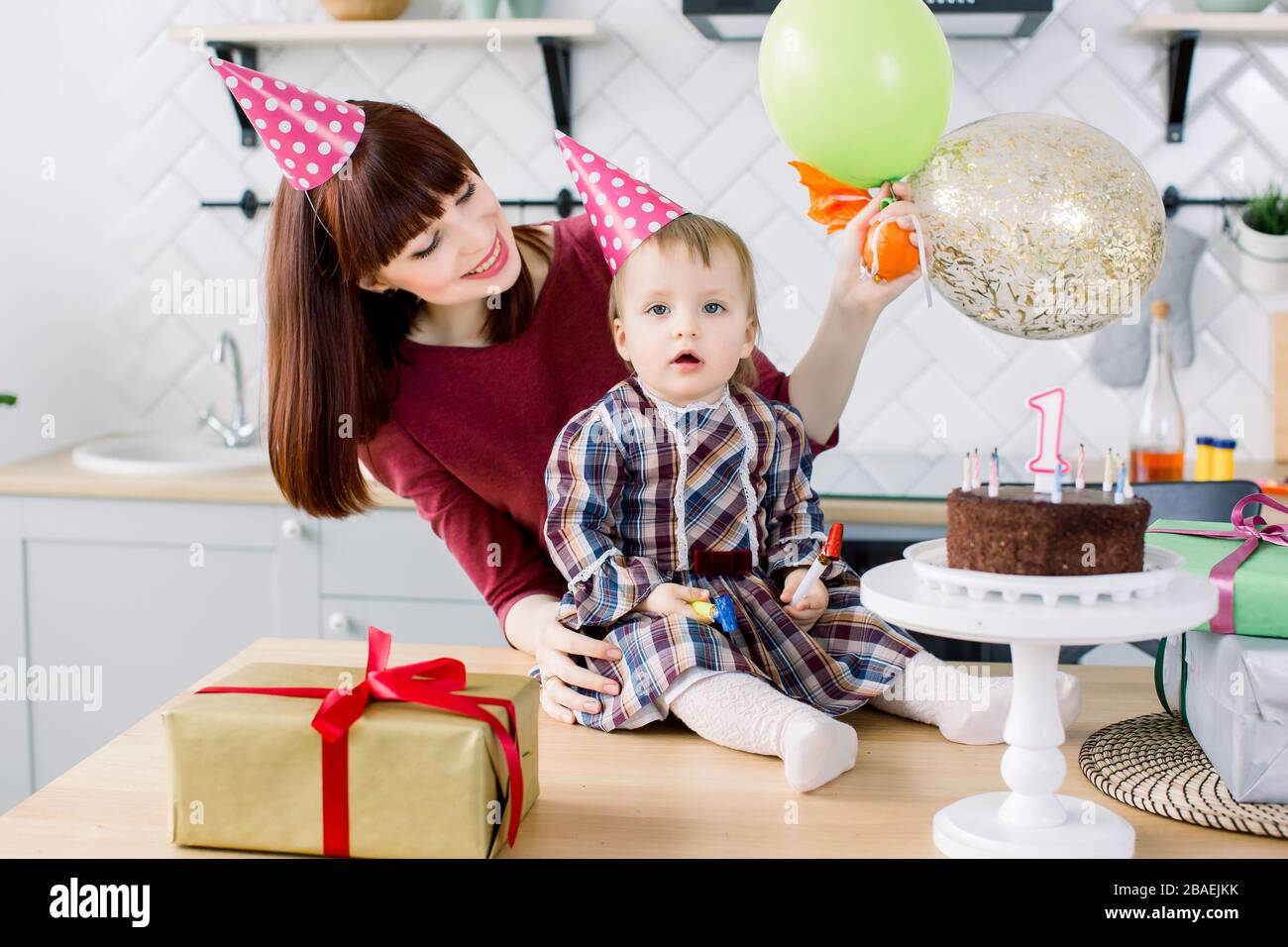 Happy mother celebrating first birthday of her baby Stock Photo - Alamy