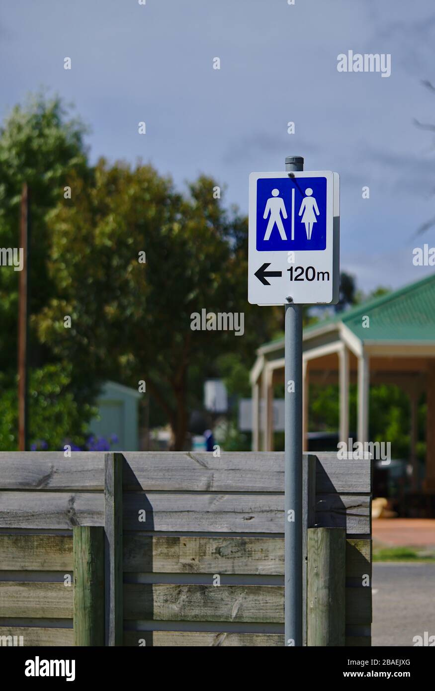 Public toilet sign in blue and white color with black arrow pointing to ...