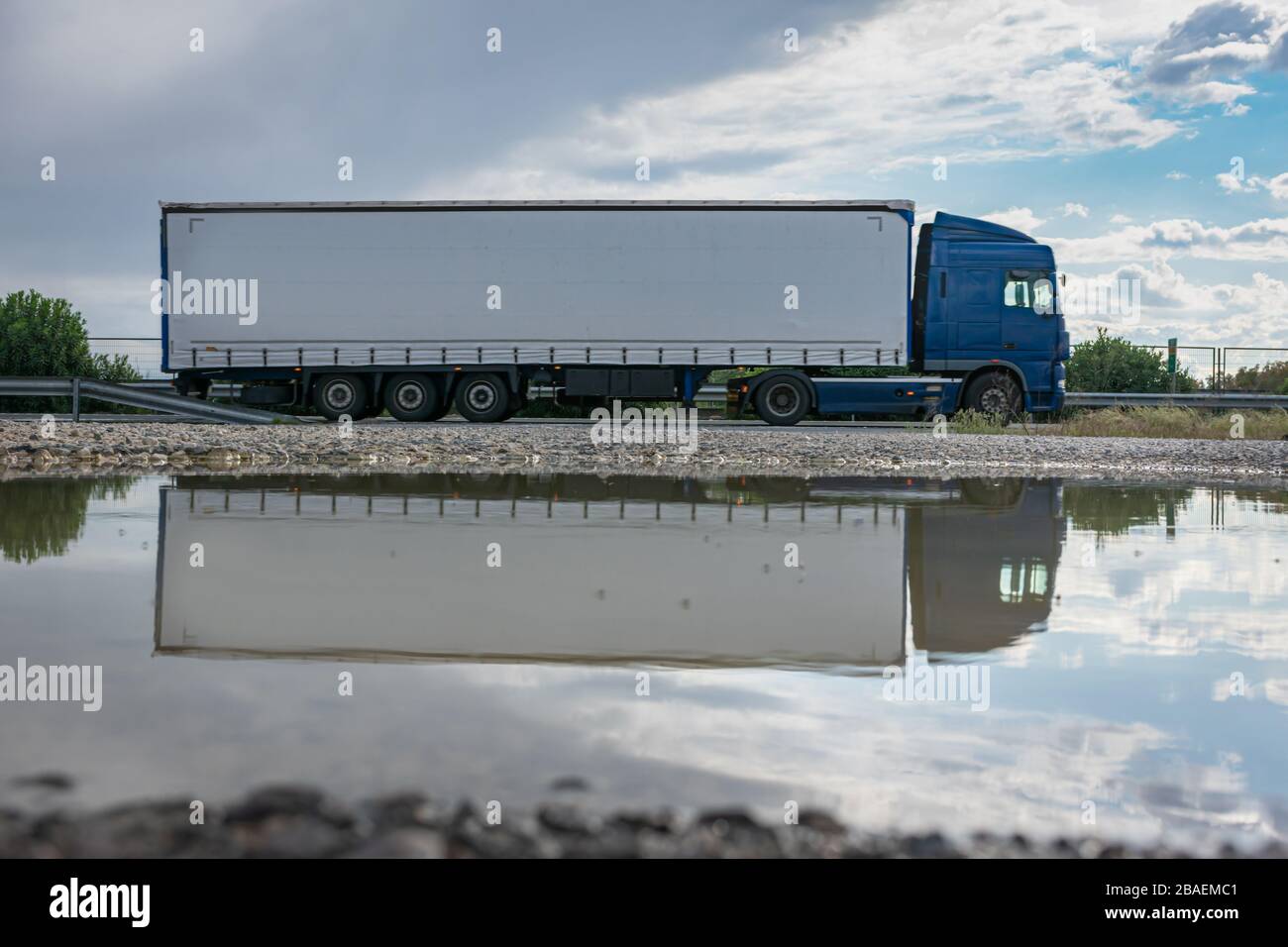 Truck with canvas semi-trailer with side opening for general transport ...
