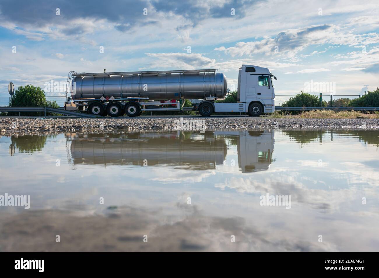 Tanker truck with flammable dangerous goods circulating on the highway ...
